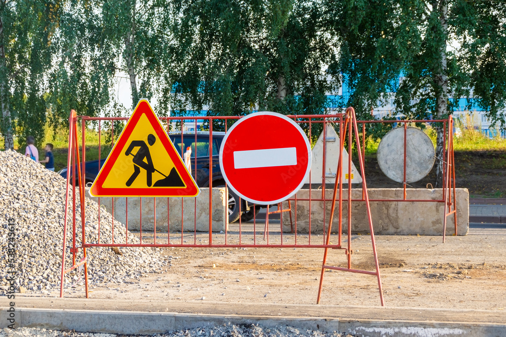signs entry is prohibited and roadworks are underway behind which there ...