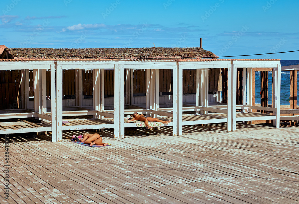 Beach designs and sexy topless sunbathing women on the beach Stock ...