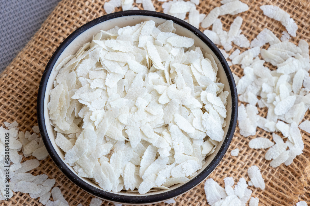 Flattened rice or beaten rice inside of carmic bowl, use in brakefast ...