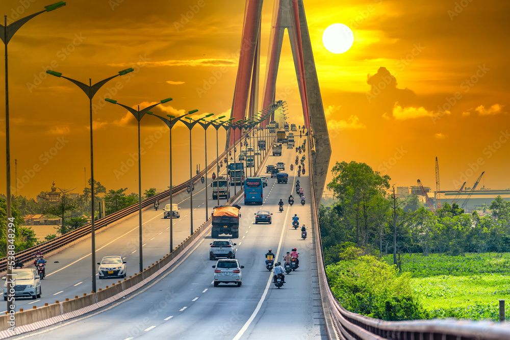 Heavy traffic on Can Tho bridge at sunset sky. Can Tho bridge is famous ...