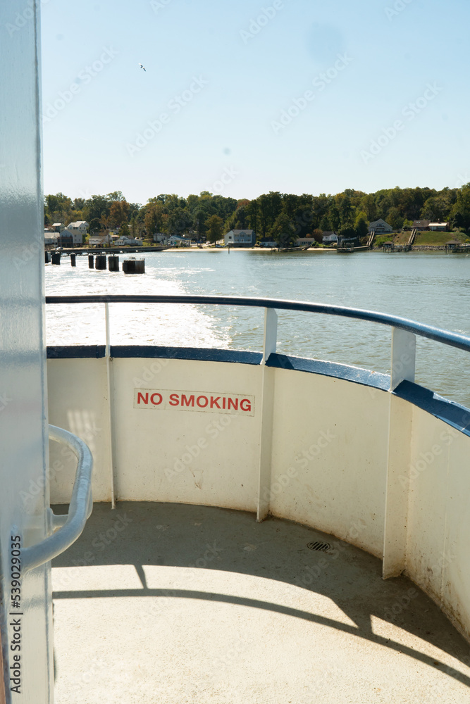 No smoking sign on deck with metal hand rail of large vessel looking ...