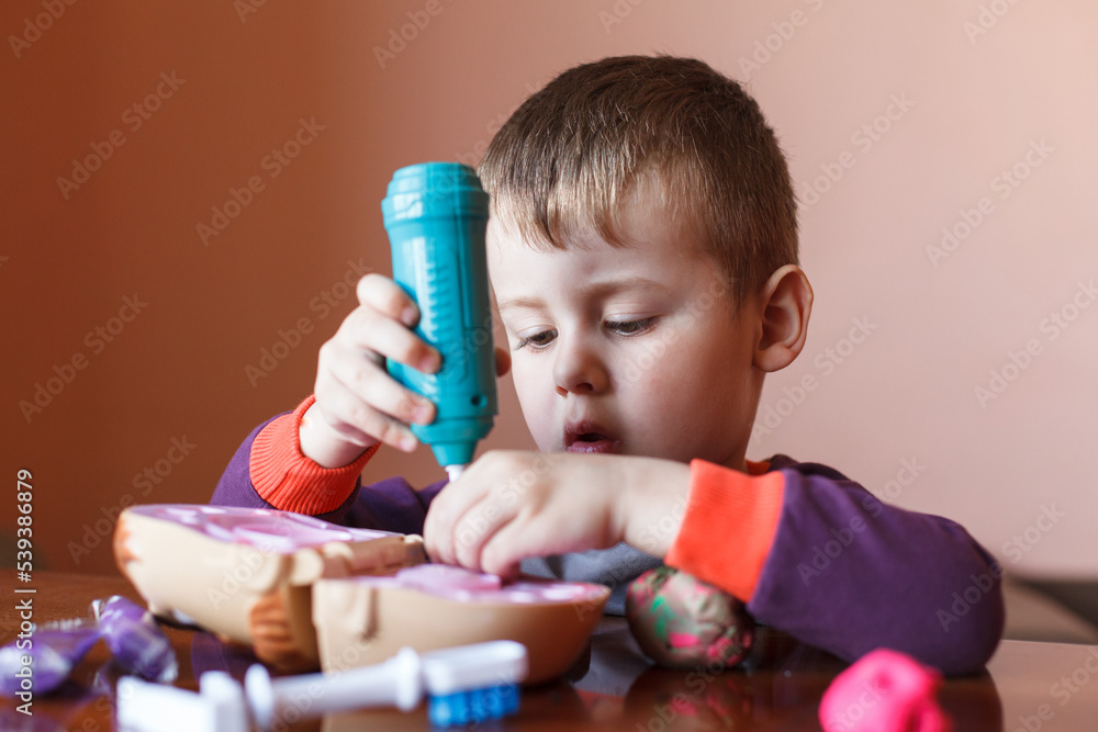 Cute little boy playing with many-colored plasticine. Boy playing with ...