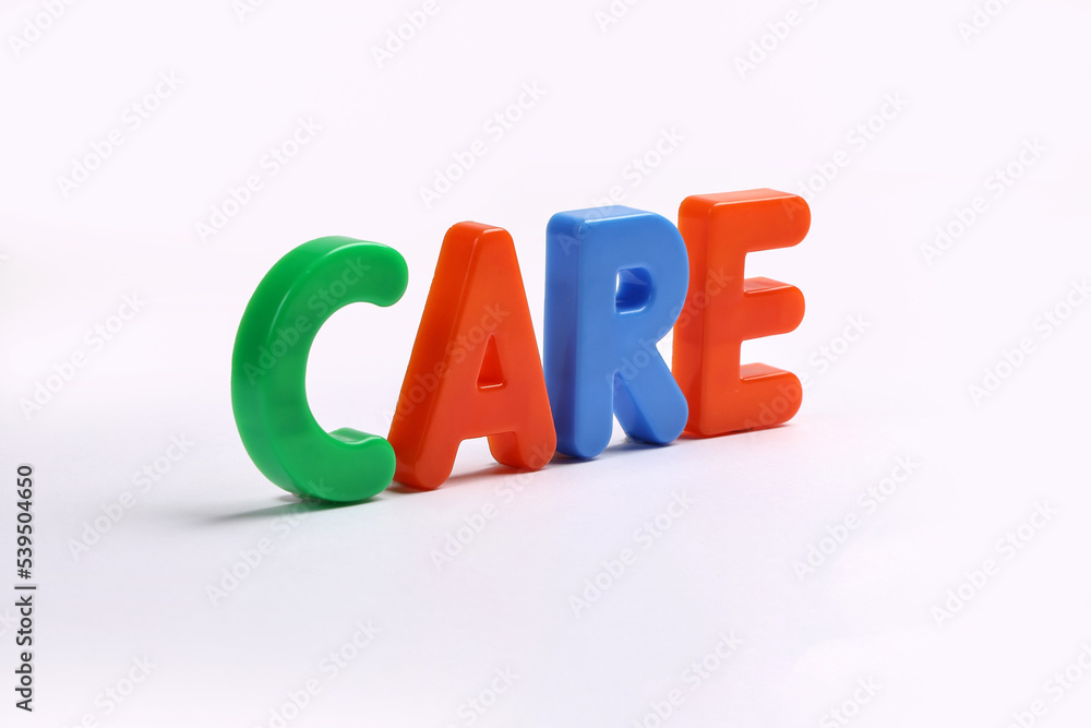 care written in red green blue plastic capital alphabet embossed colour ...