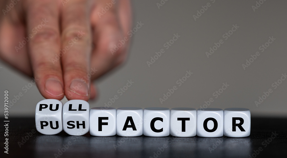 Dice form the expression 'pull factor' and 'push factor'. Symbol for reasons of migration. Stock ...