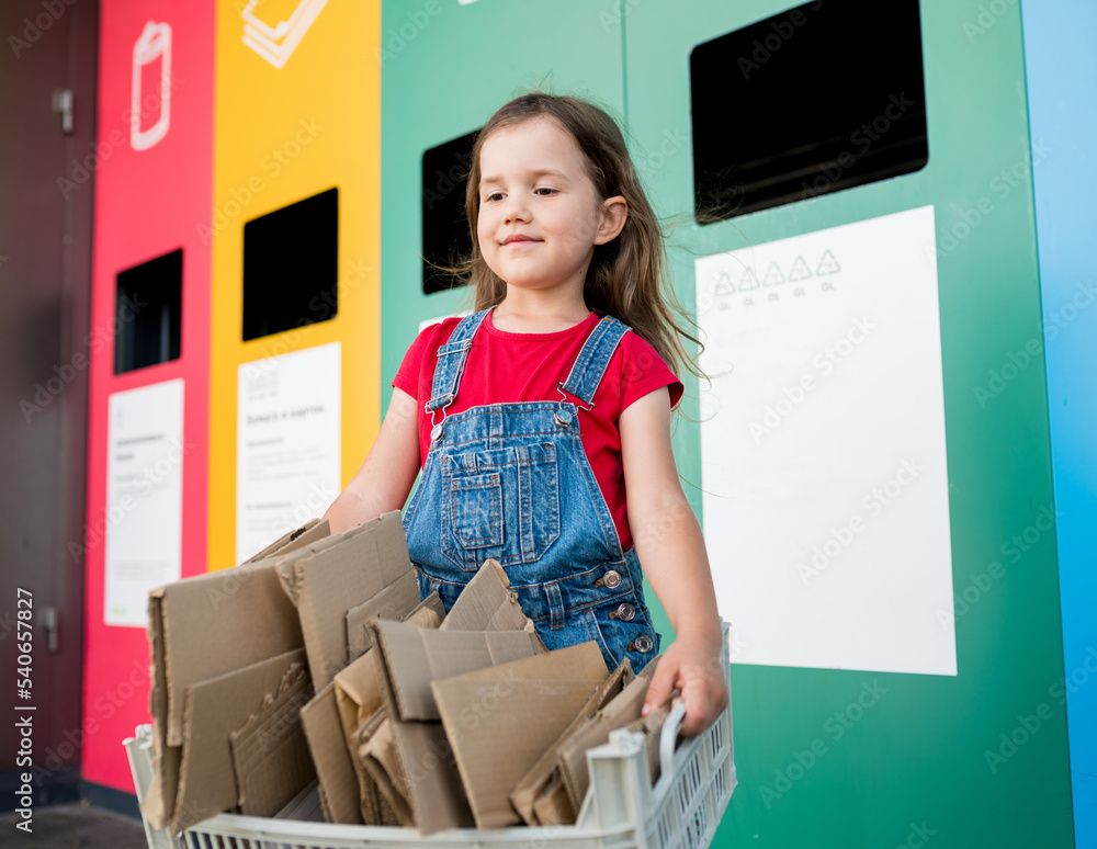 Portrait of cute girl holding box with cardboard for reduce, reuse ...