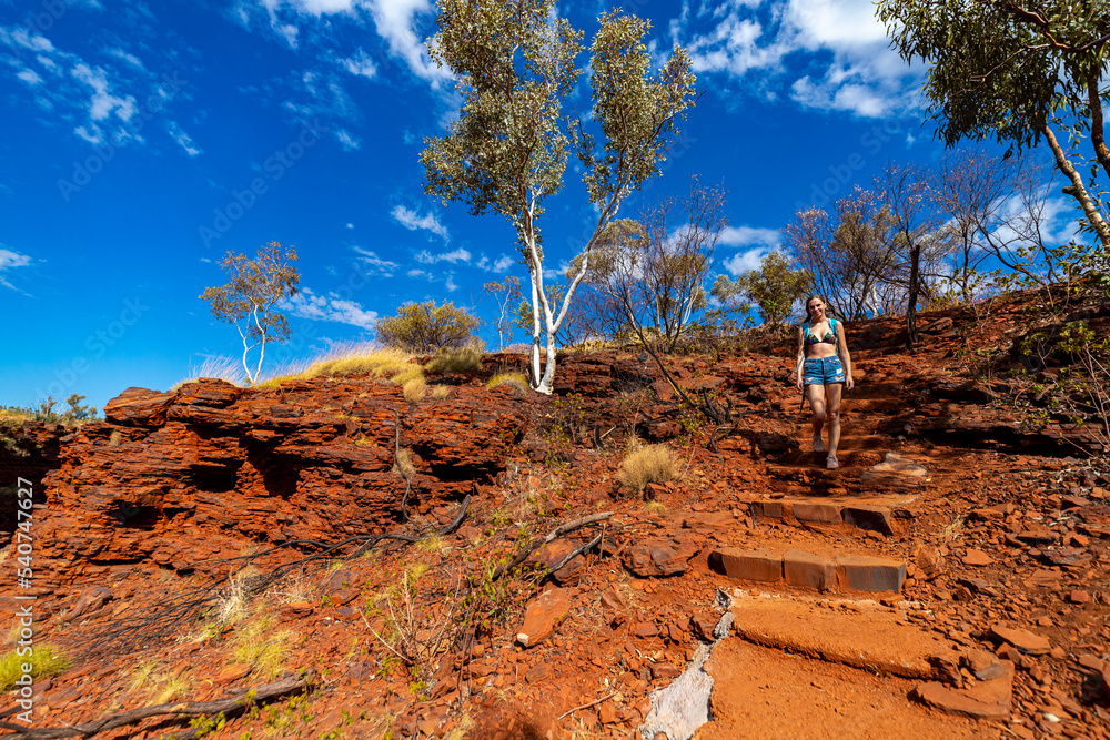 girl in shorts hiking in karijini national park, western australia ...