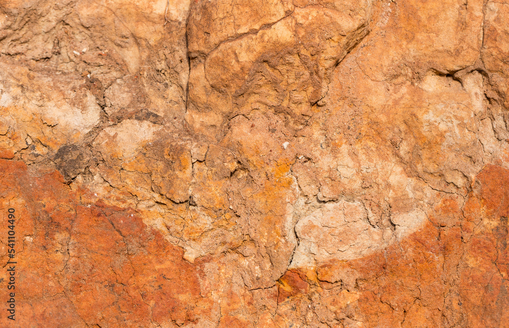 Sedimentary rocks with a high content of iron oxide. Red soil, loam ...