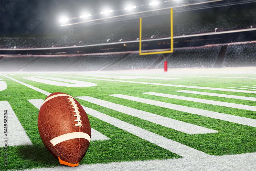 American football field goal post in fictitious stadium with ball on ...