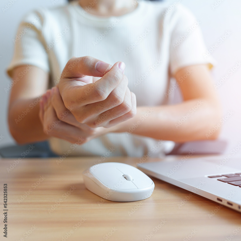 Woman having wrist pain when using mouse during working long time on ...