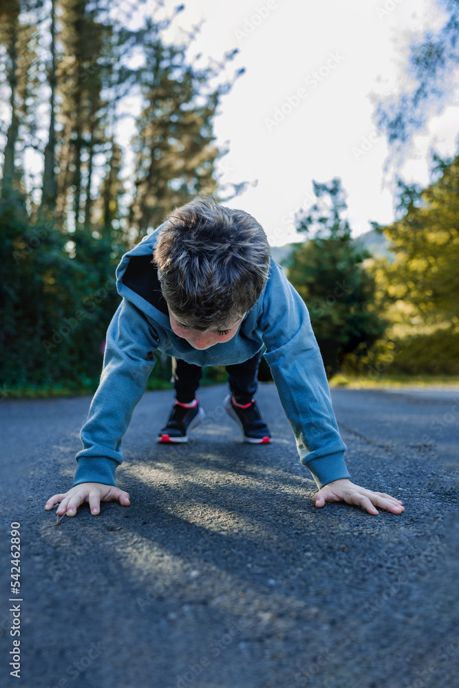 Preteen child pushing up in nature Stock Photo | Adobe Stock