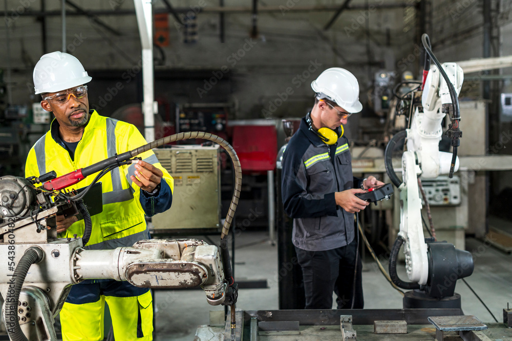 Robotics control engineers solve problems control panel of robot for setting programming for ...