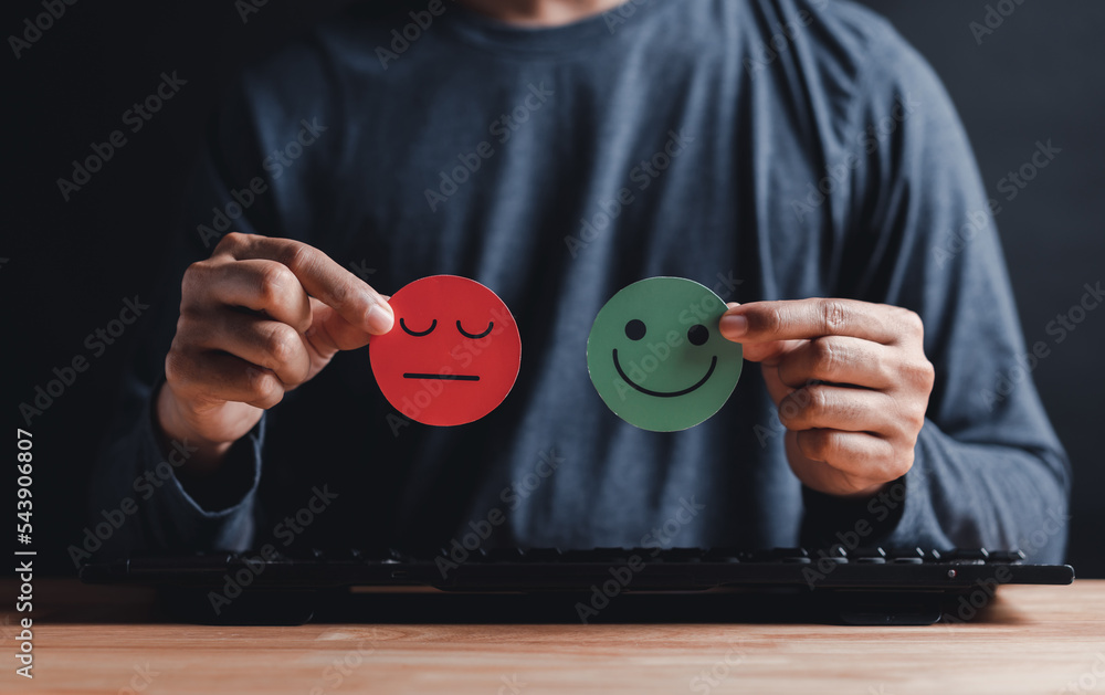 Man Hands holding sad face hiding or behind happy smiley face, bipolar ...