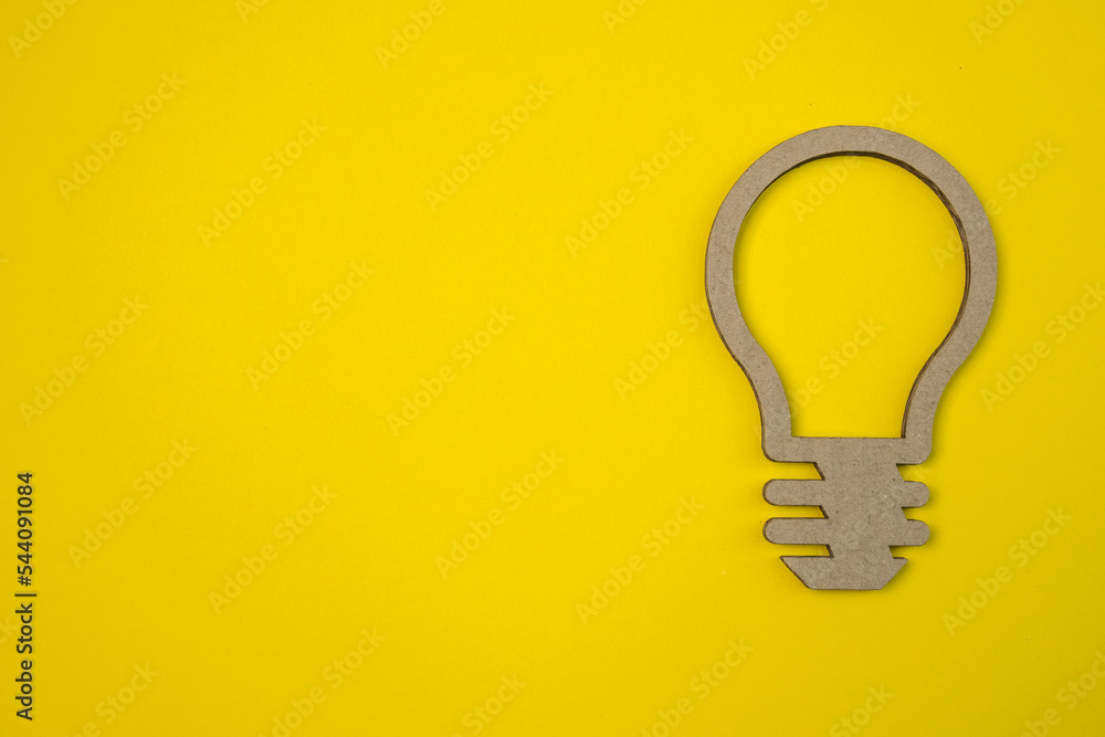 Light bulb cut out on a corrugated cardboard. Flat lay design symbol of ...