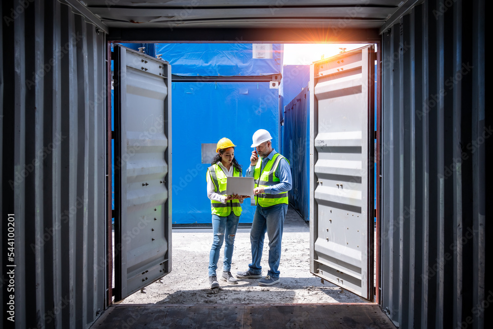 Engineer working in the construction container dock yard checking and ...