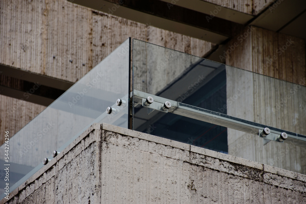 glass railing and balustrade over stone parapet. balcony guard rail ...