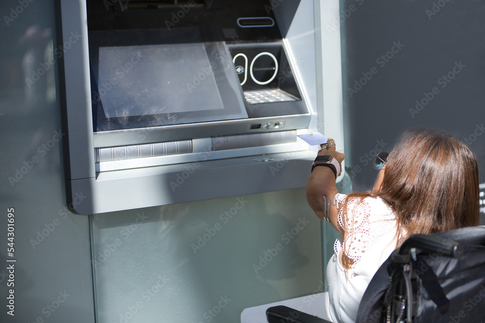 Disabled woman with reduced mobility and small stature in an electric ...
