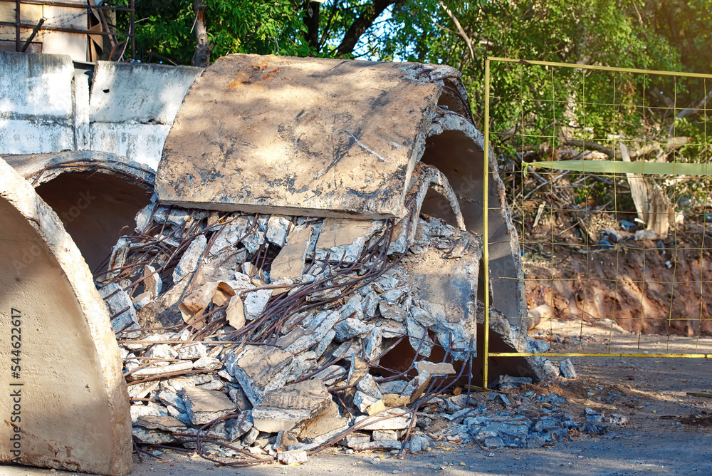 Damaged cement precast pipeline stacked near trench, replacement of the ...