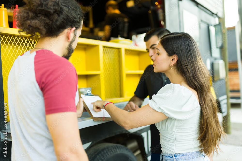 Customers looking at the street food menu at the food truck Stock Photo ...