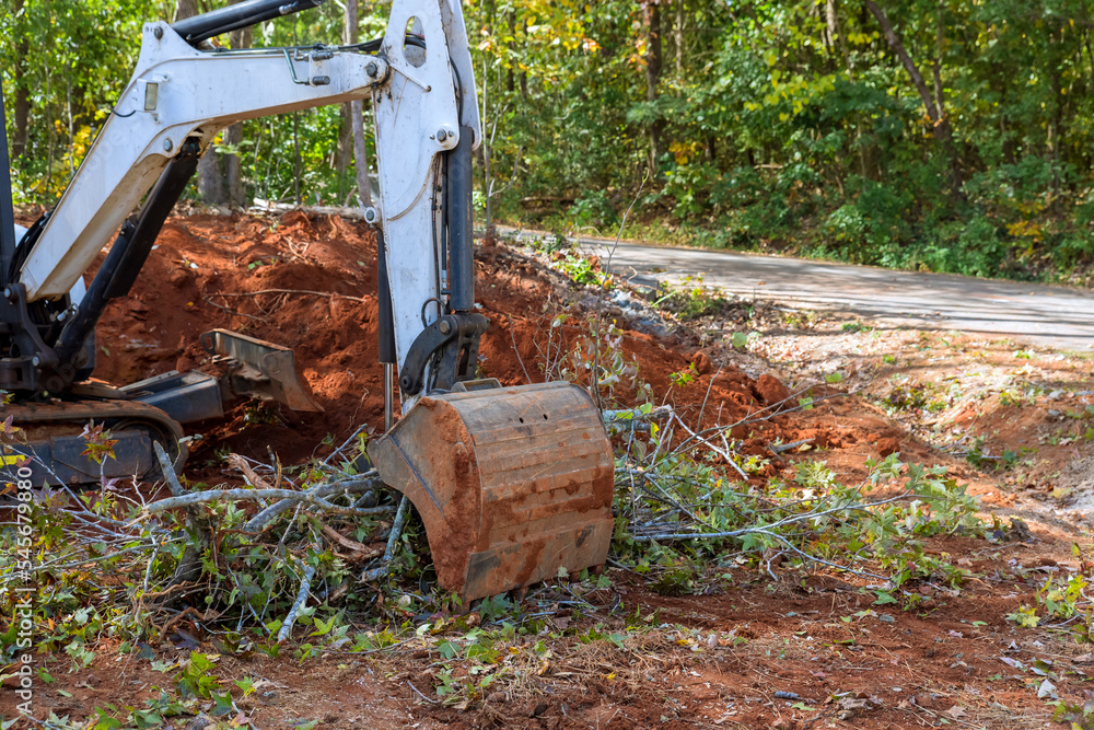 Tractor skid steer was used to clear trees roots for building of ...