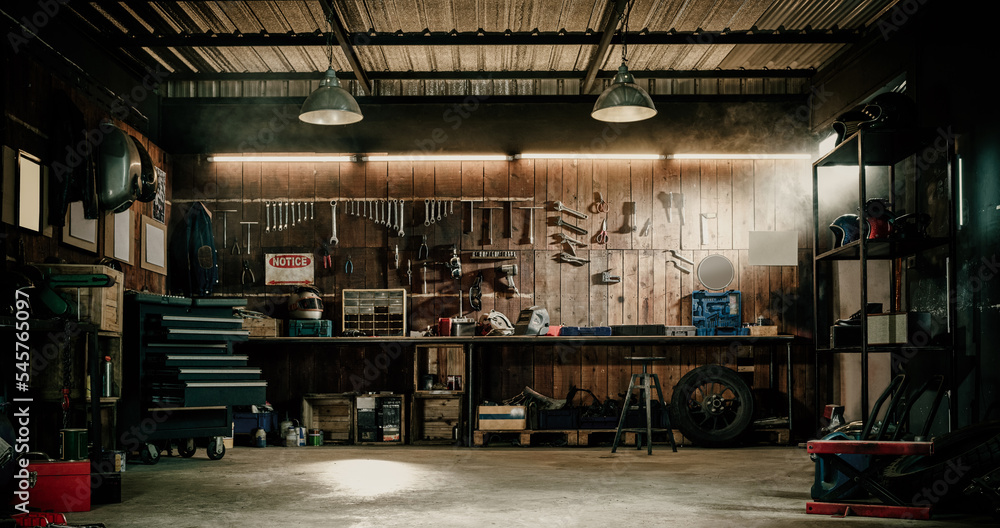 Workshop scene. Old tools hanging on wall in workshop, Tool shelf against a table and wall ...