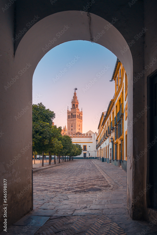 Arched passage near historical tall tower in Seville Stock Photo ...