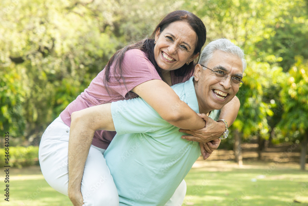 Happy indian senior couple enjoying life having fun at summer park, man ...
