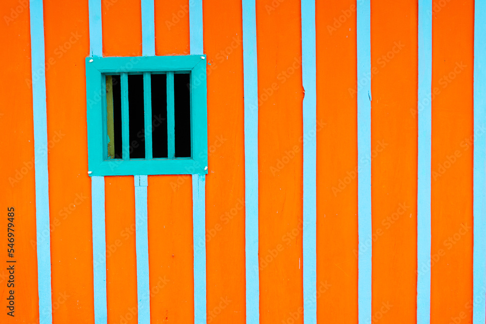 dors and windos decorete the wooden walls of a characteristic little ...