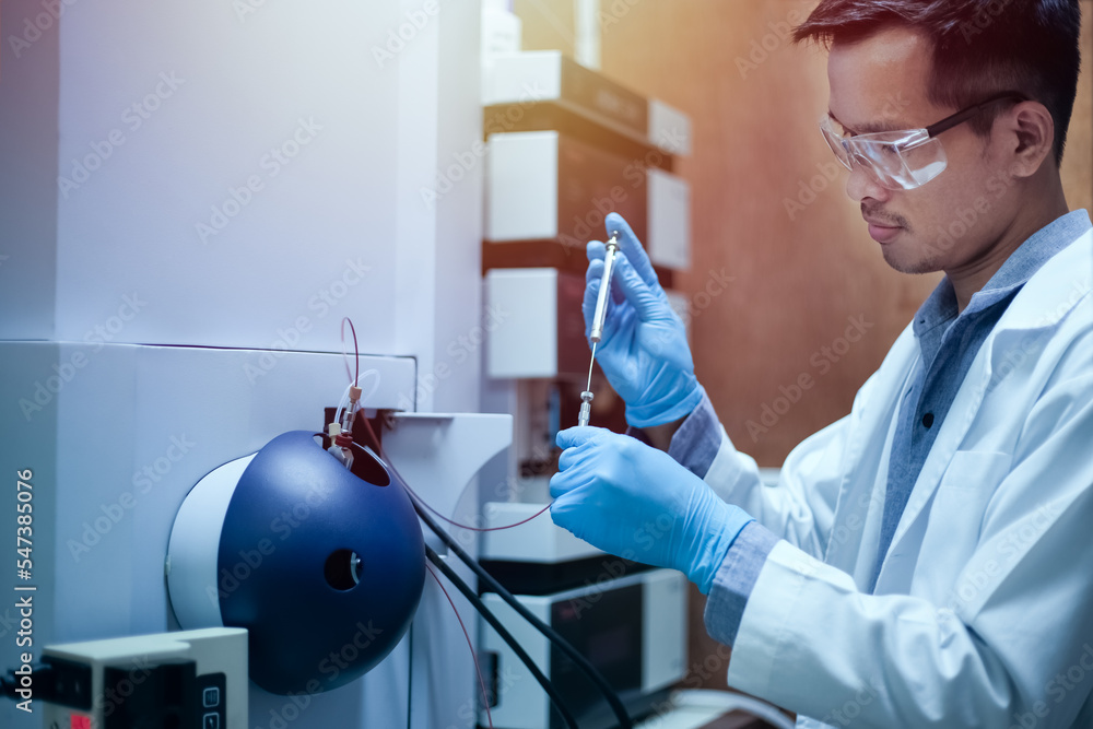 Scientist man analyzing a sample using the high-performance analytical ...