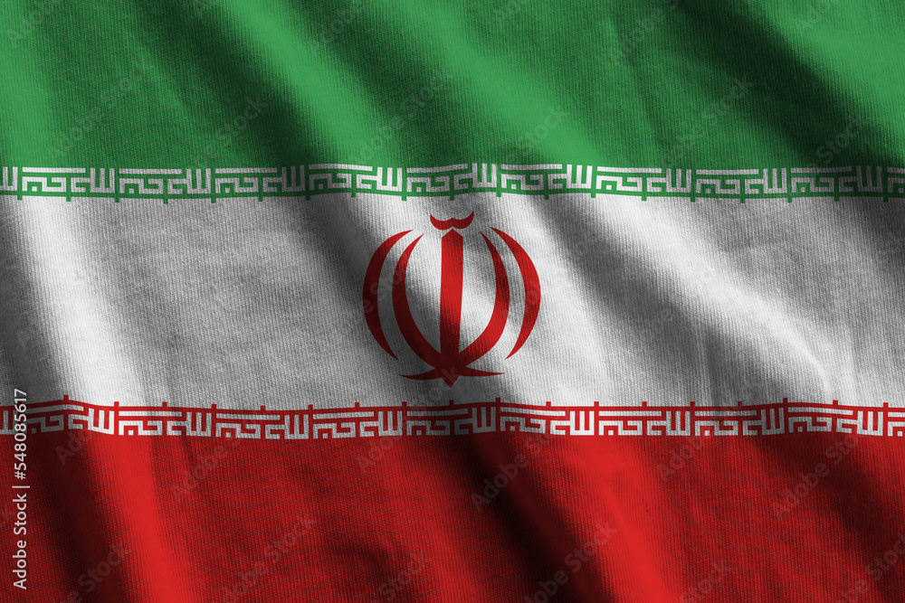 Iran flag with big folds waving close up under the studio light indoors ...