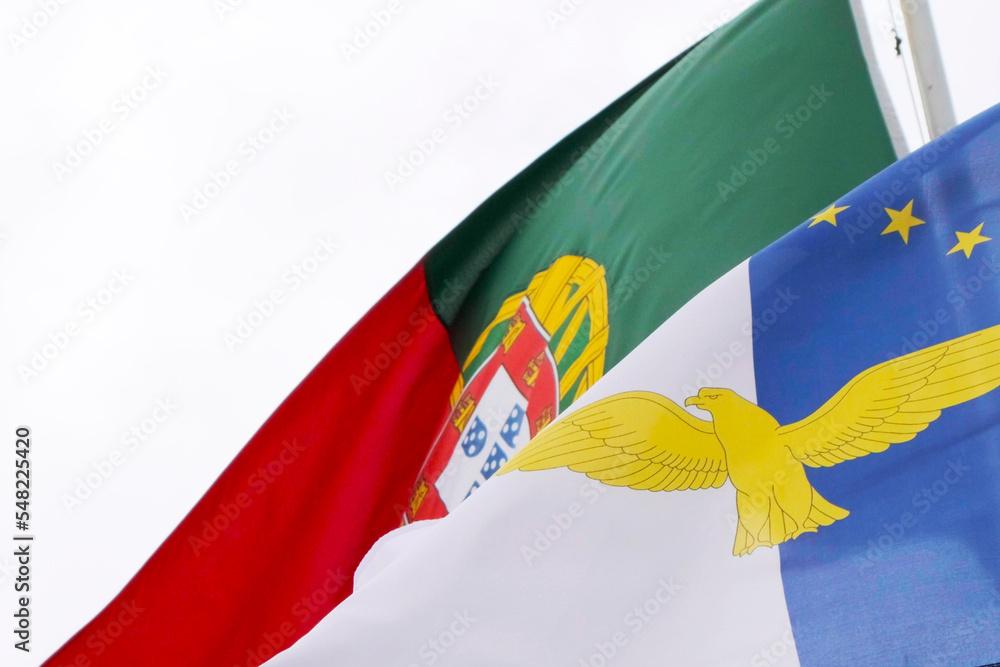 Azores and Portugal Official Flags bouncing in the air on a windy day ...