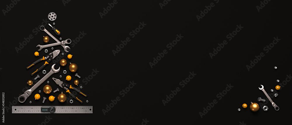 A symbolic Christmas tree made of construction tools on a black ...