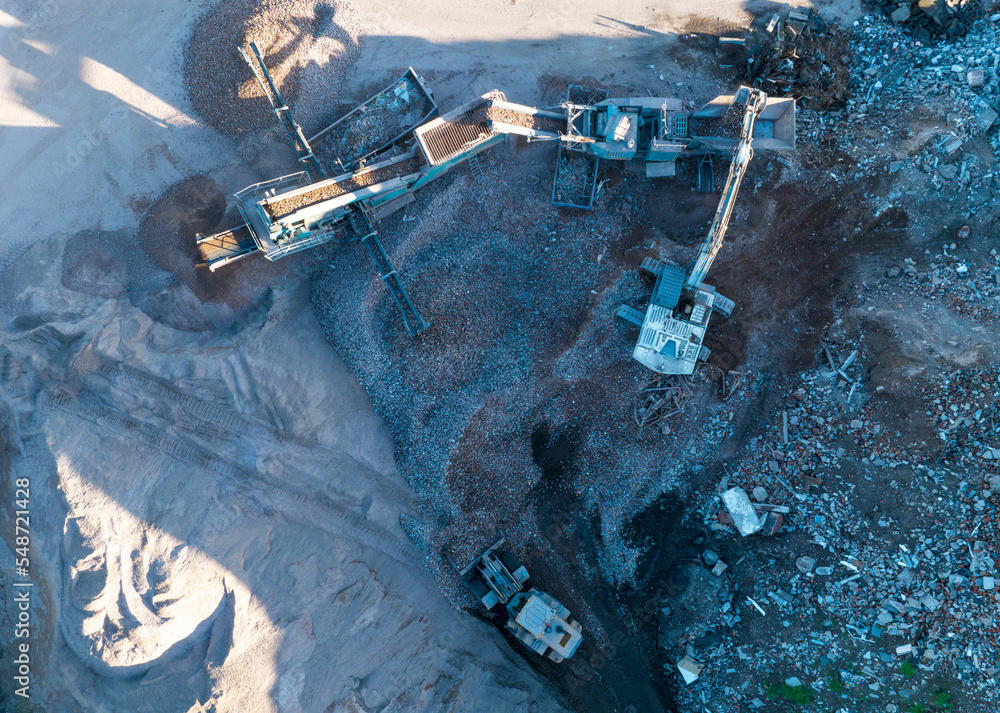 Concrete Recycling and asphalt from demolition. Excavator at landfill ...