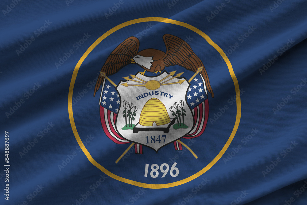 Utah US state flag with big folds waving close up under the studio ...