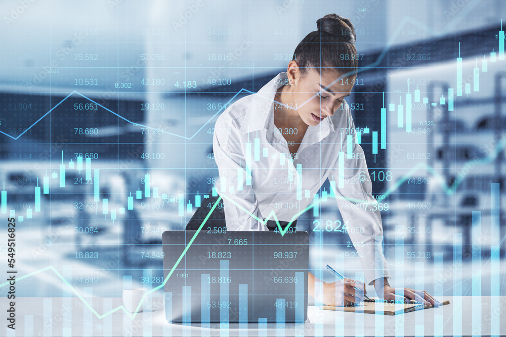 businesswoman leaning and writing on desktop with glowing business ...