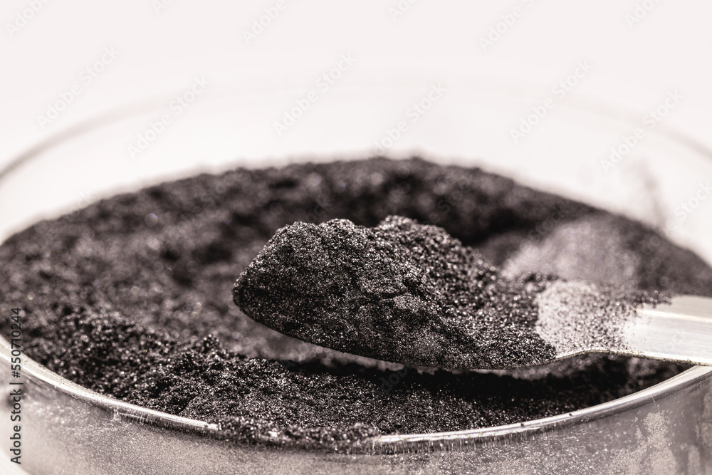 black pigment, powder for industrial or cosmetic use, isolated white ...