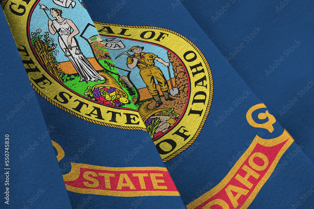 Idaho US state flag with big folds waving close up under the studio ...