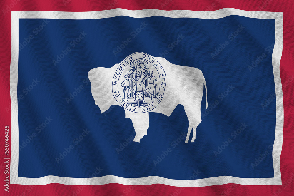 Wyoming US state flag with big folds waving close up under the studio ...