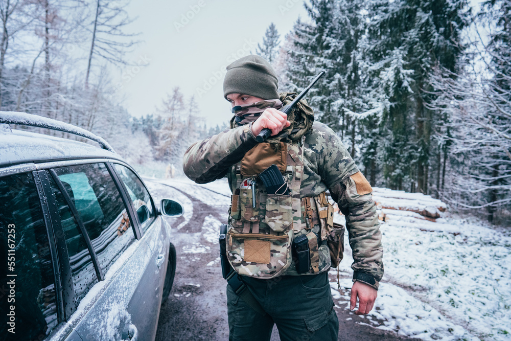 Member of the military police breaks the window of a passenger vehicle ...
