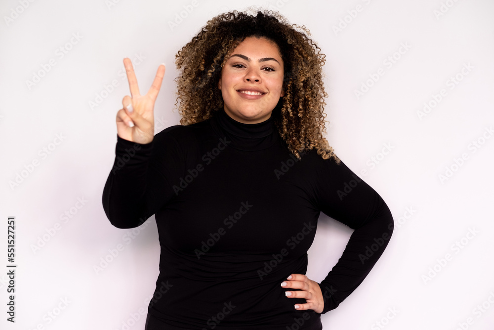 Cheerful young woman making peace sign with her hand. Female African ...