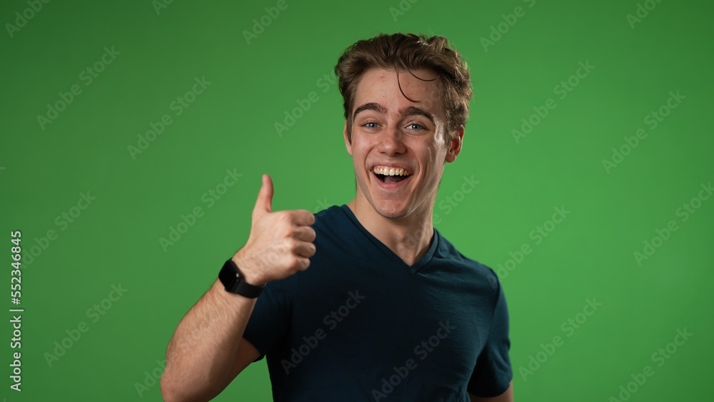 Smiling happy satisfied young man 20s turn around to camera showing ...