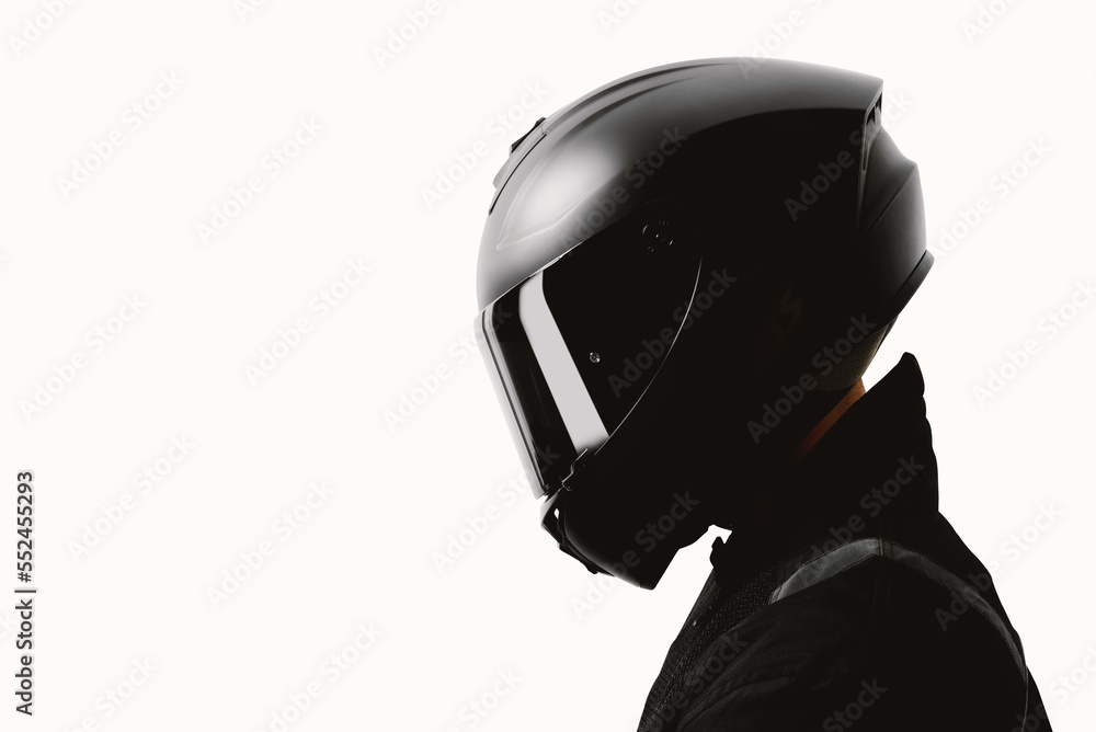 Portrait of a motorcycle rider posing with a black helmet on a white ...