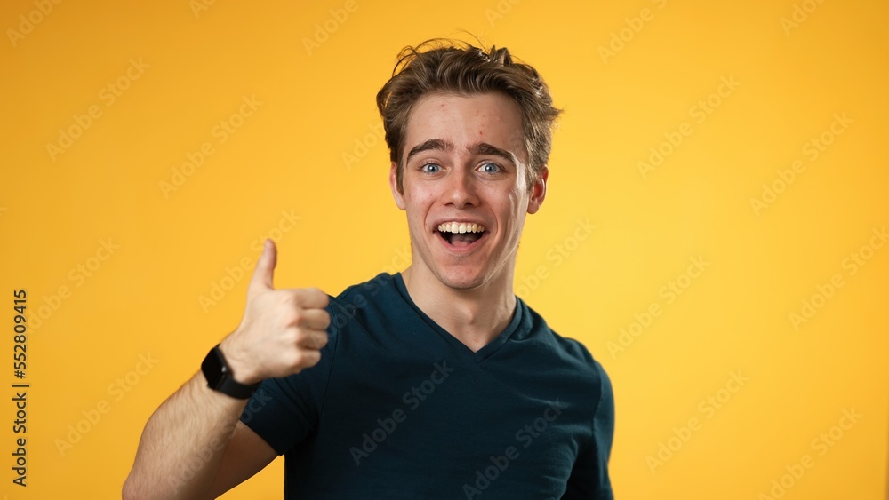 Handsome thinking young man 20s, looks at camera gives mind blown ...