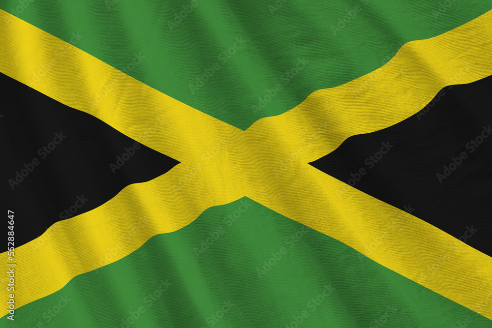 Jamaica flag with big folds waving close up under the studio light ...