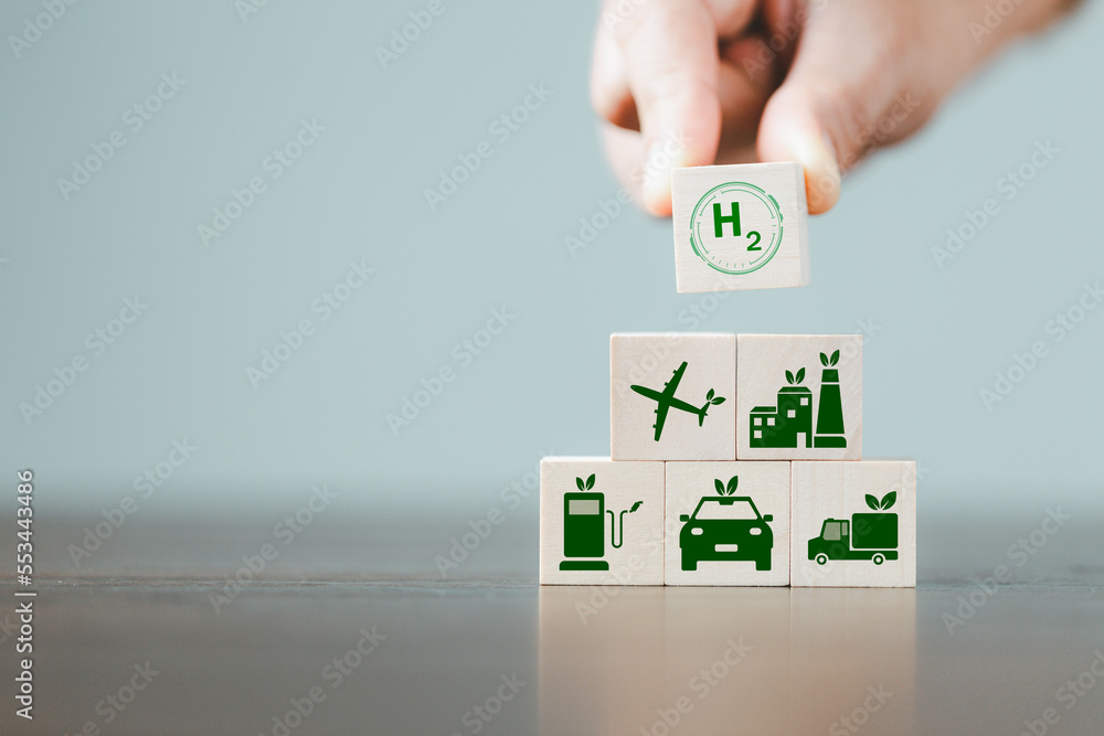 Free Carbon, alternative energy and global climate change concepts. Hand flipping wooden cube ...