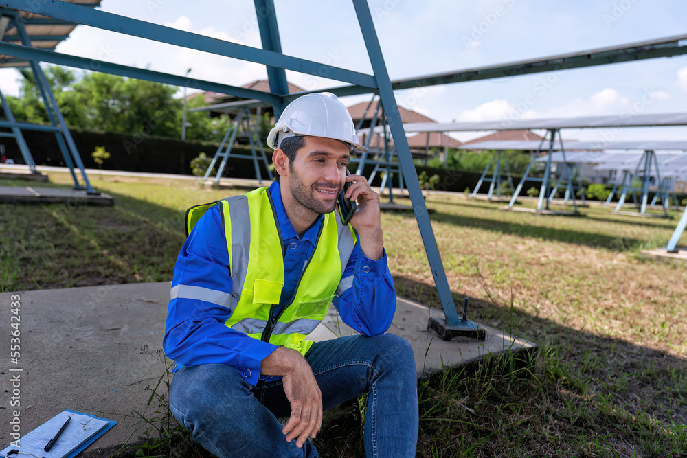 Engineer at solar farm on break time sitting look social media from ...