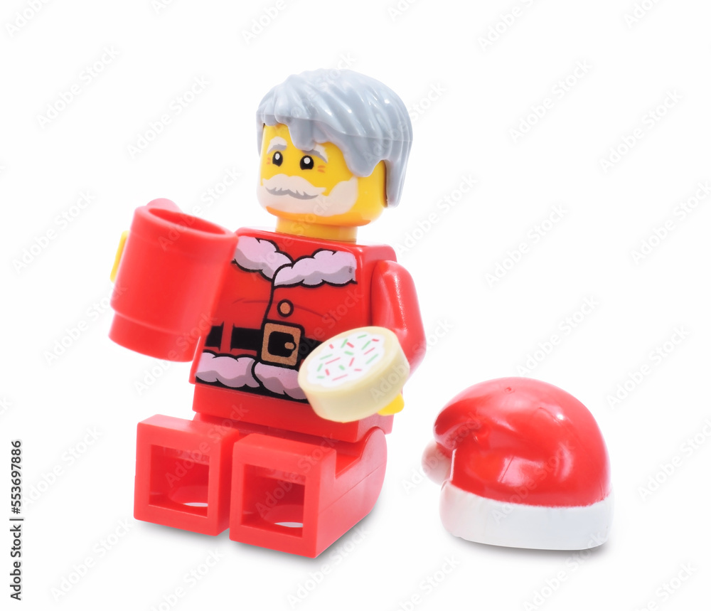 Lego minifigure of Santa Claus is drinking milk and eating a cookie ...