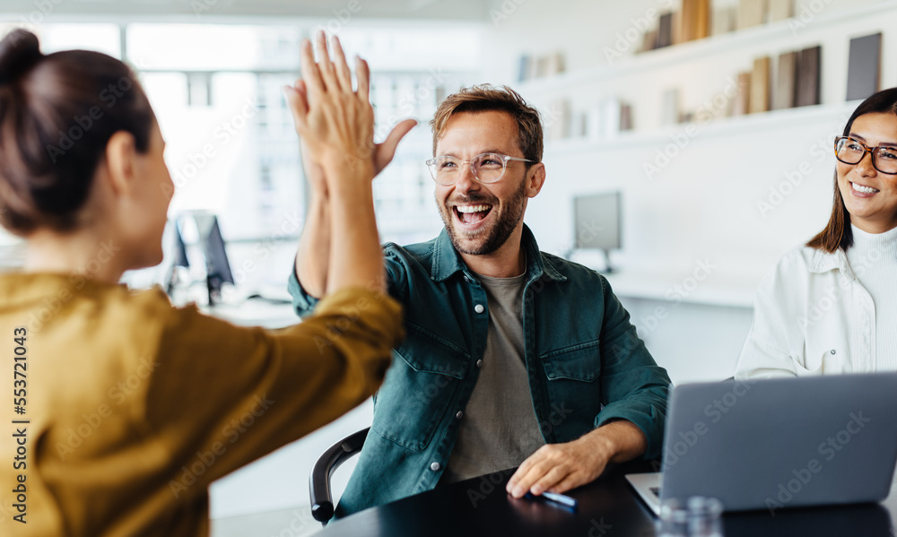 Business people celebrating success in an office Stock Photo | Adobe Stock