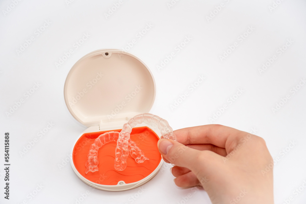 Transparent aligners retainers in a storage case. Invisible braces ...