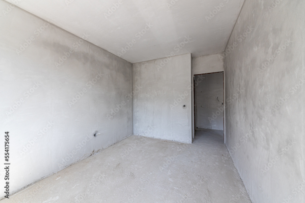 New empty room under construction. Plaster walls. New home. Concrete ...