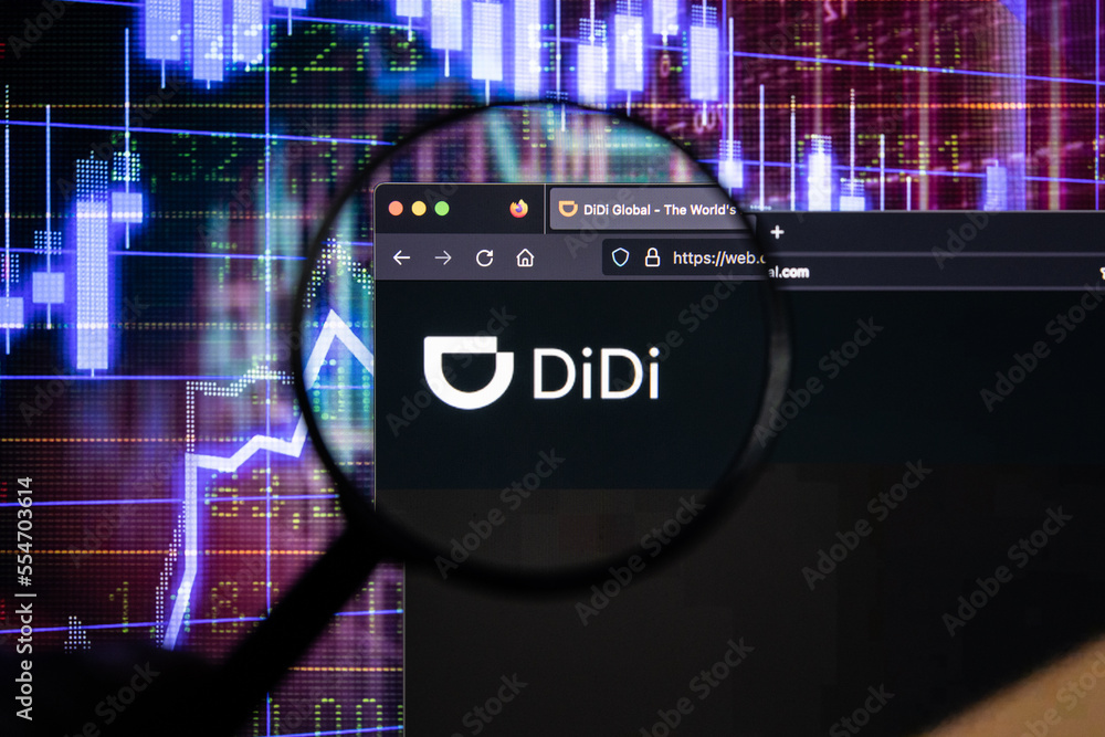 DiDi company logo on a website with blurry stock market developments in ...